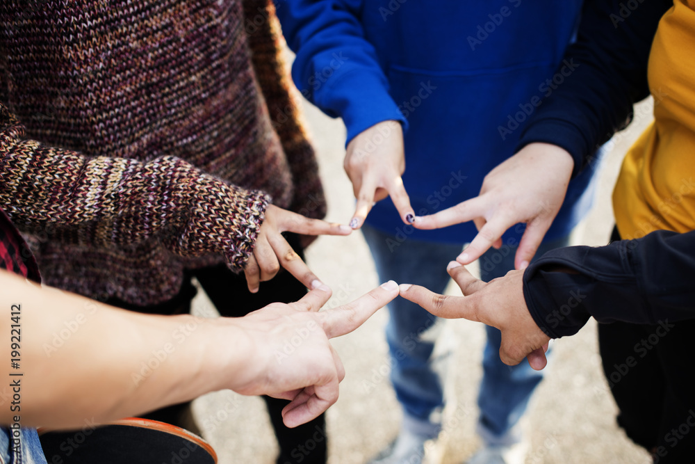 Group of friends using fingers to form the star shape teamwork and ...