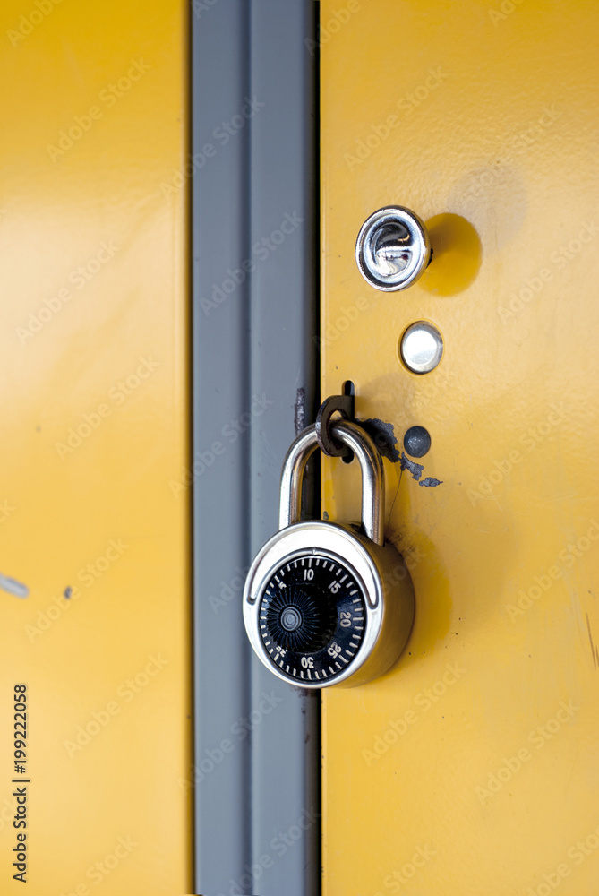 Yellow School Locker with Black Combination Lock - The door of a yellow ...