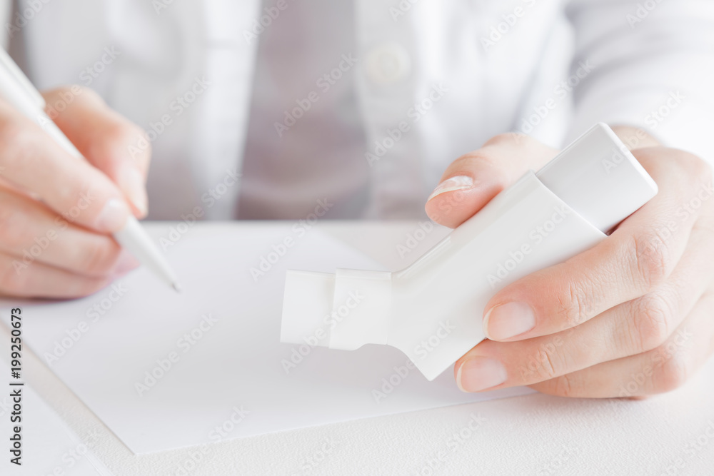 Doctor writing prescription. Hand giving inhaler of asthma for ...