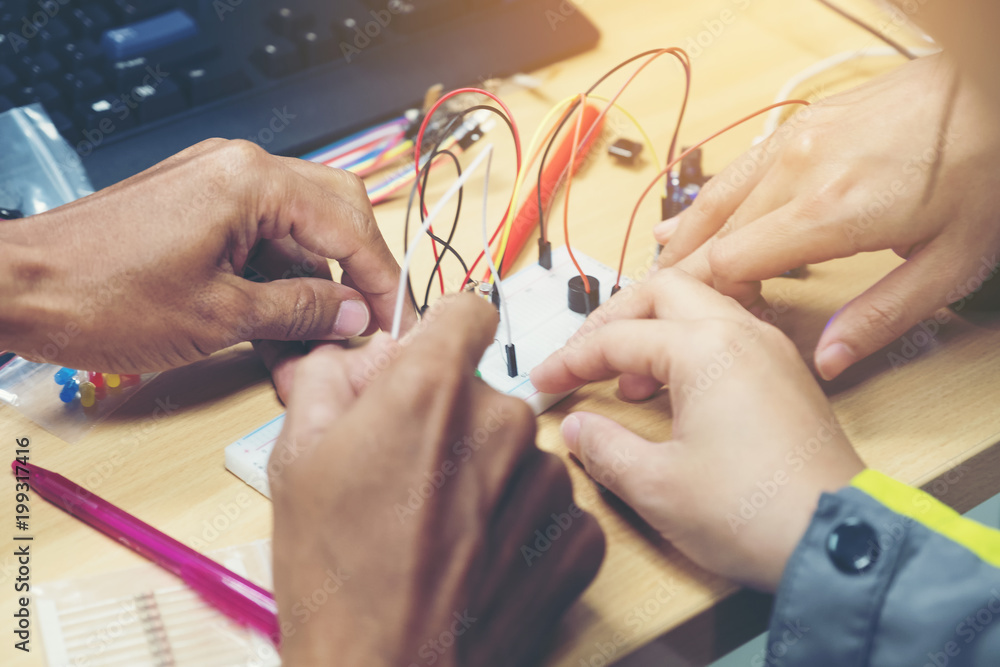 Hands group work shop electronic control kit DIY boards flat layout ...