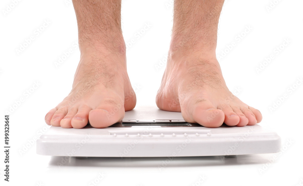 Man standing on weight scale Stock Photo | Adobe Stock
