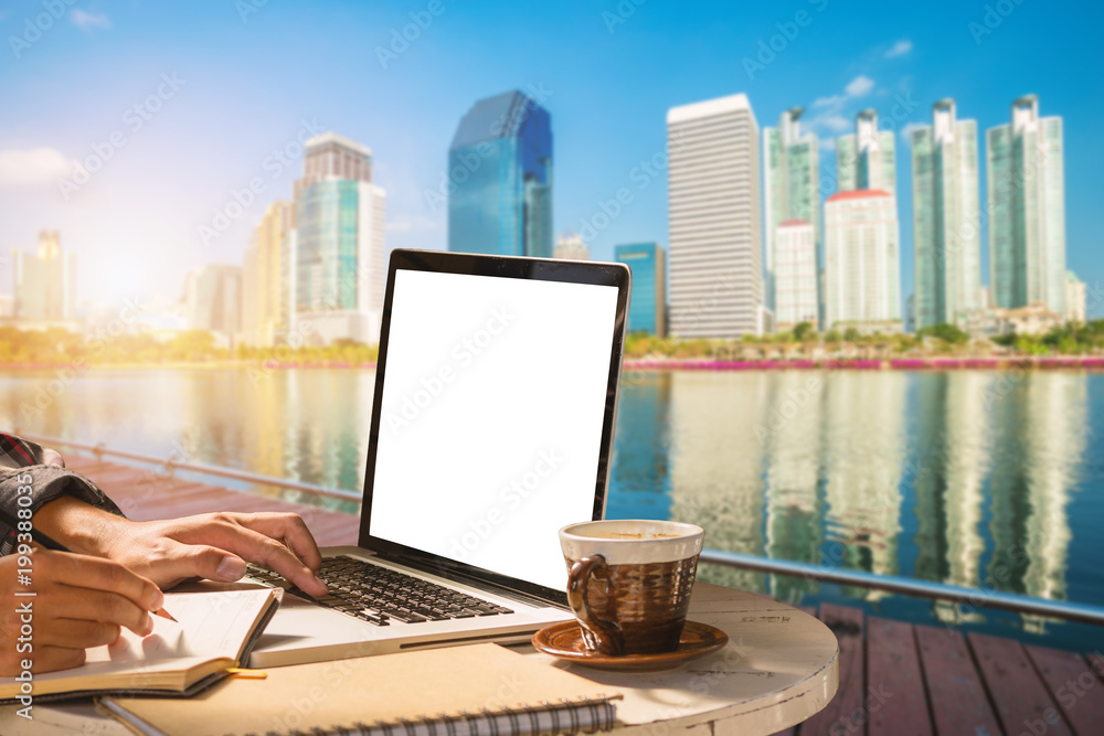 Businessman working with of laptop with blank white screen and coffee ...