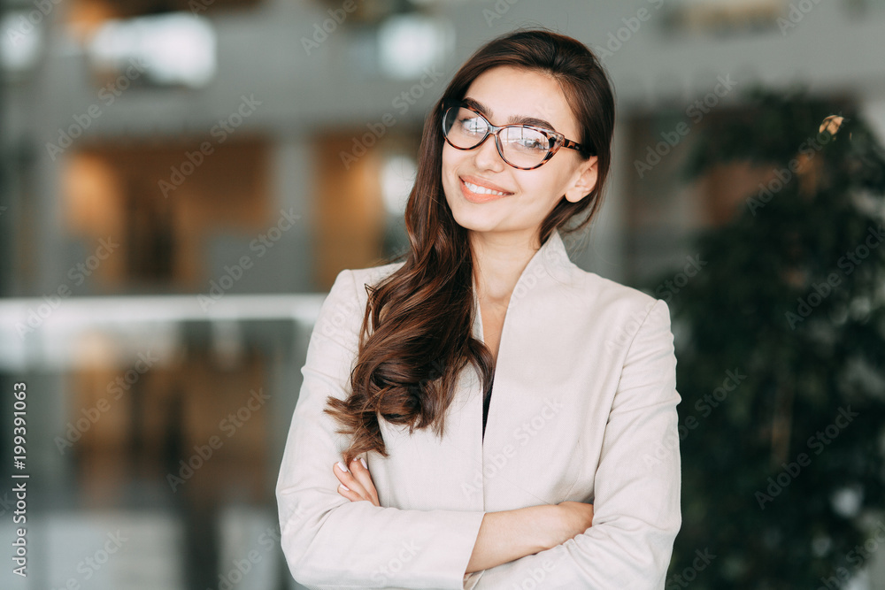 Beautiful Russian business girl with glasses, standing with arms ...