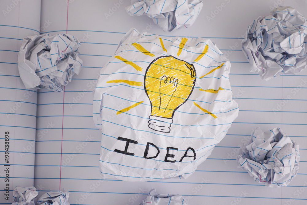 Drawing of a light bulb with word Idea on crumpled paper ball Stock ...