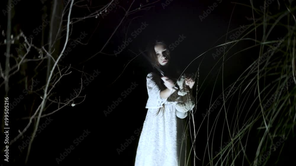 A little ghost girl with long black hair, in white, wandering through ...