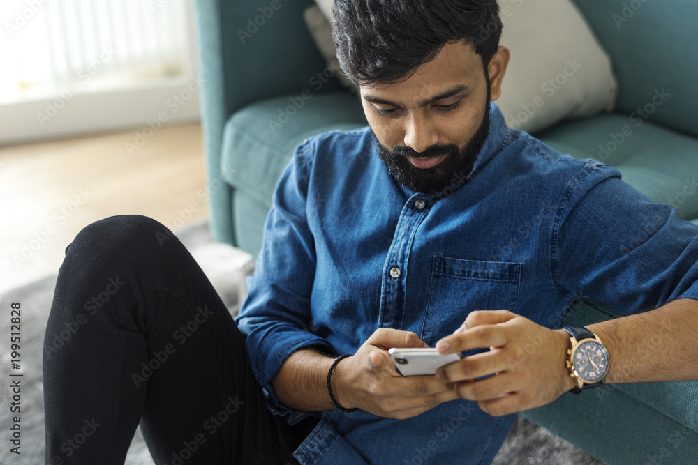 Man using mobile phone on the floor Stock Photo | Adobe Stock