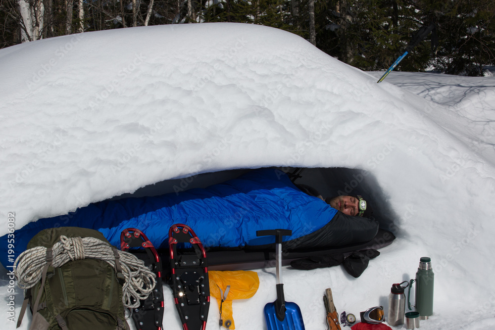 Man is sleeping in a snow cave, cross section Stock Photo | Adobe Stock