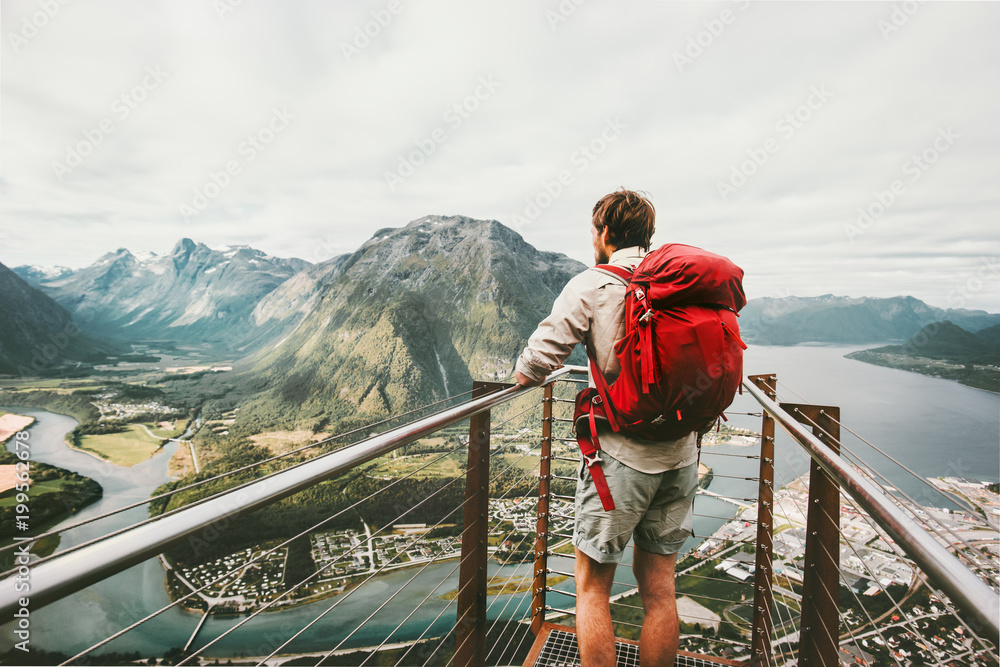 Adventurer man with red backpack enjoying mountains scenery Travel ...