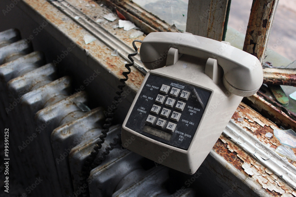 Old broken telephone in waiting room of abandoned hospital building ...