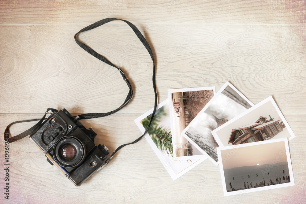Retro camera and empty old instant paper photo album on wood table with ...
