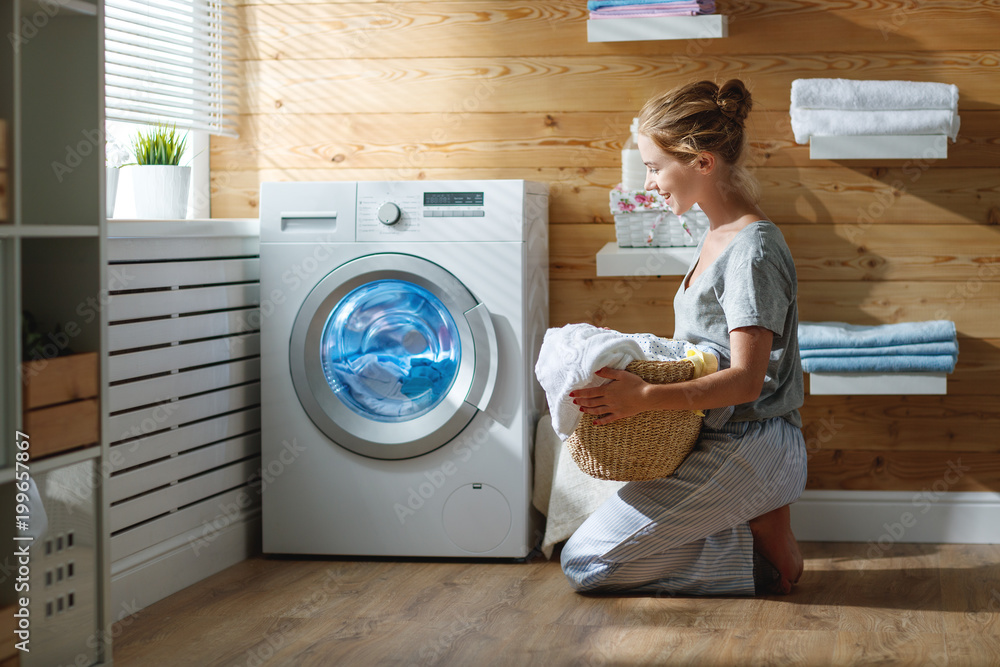 Happy housewife woman in laundry room with washing machine . Stock ...