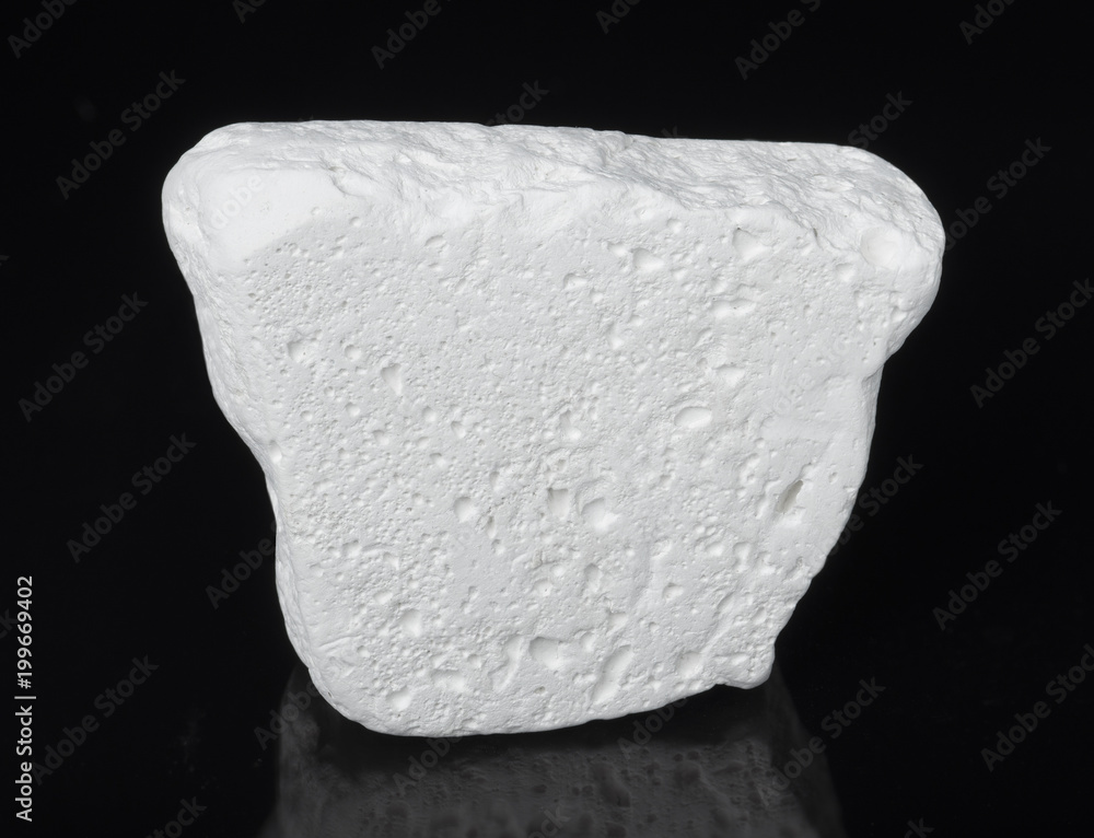 Specimen of Mineral kaolinite (kaolin) on black background. The main ...