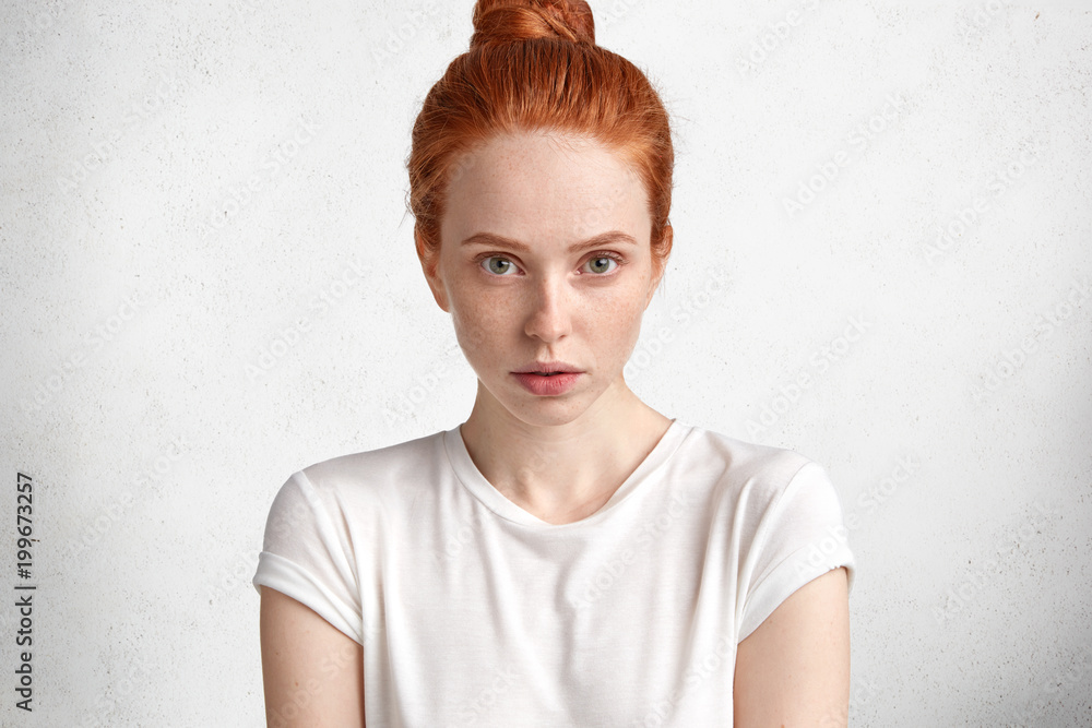Confident adorable lovely young ginger female with attractive look, has ...