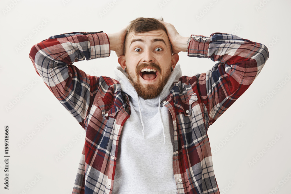 Guy is yelling from great emotions. Attractive shocked european guy ...