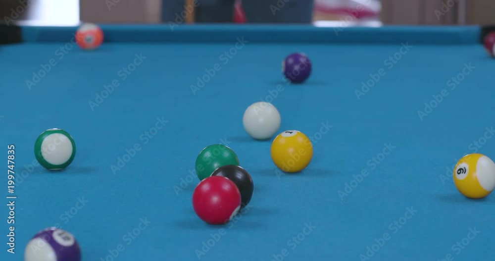 Man Breaking Racked Pool Balls in Eight-Ball Formation on Blue ...