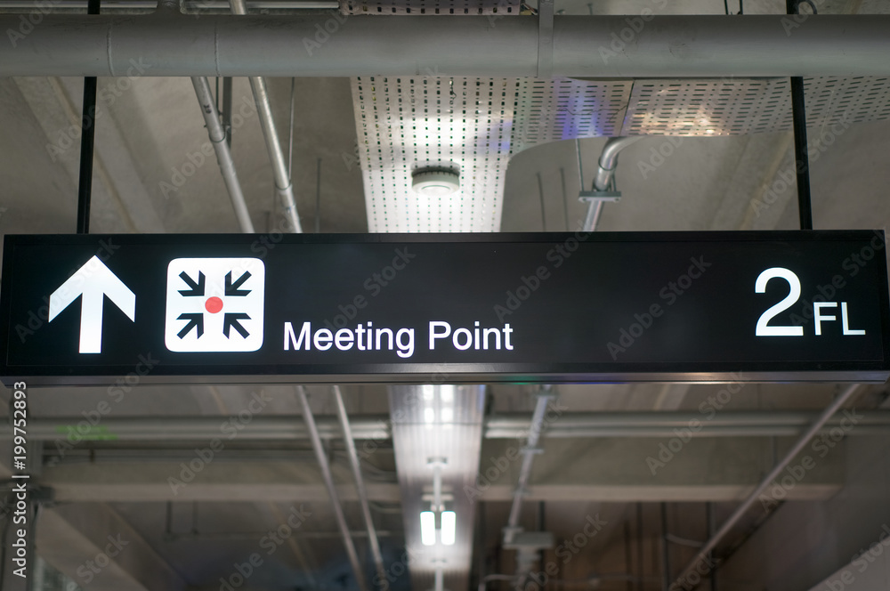 Meeting point information board sign at international airport terminal ...
