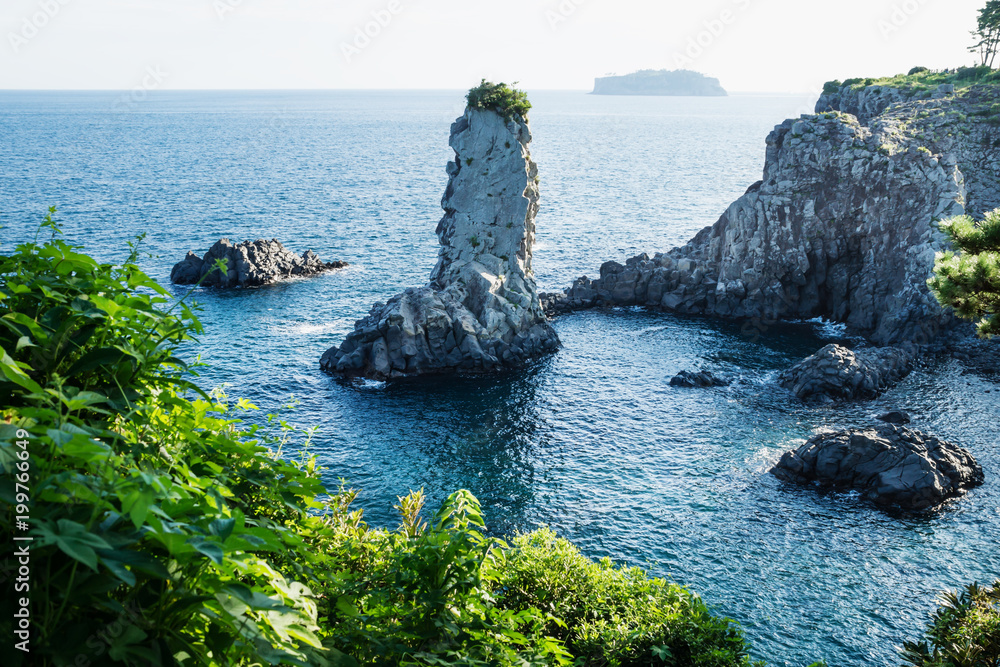 Rock formation Oedolgae in dark blue ocean at Seogwipo, Jeju Island ...