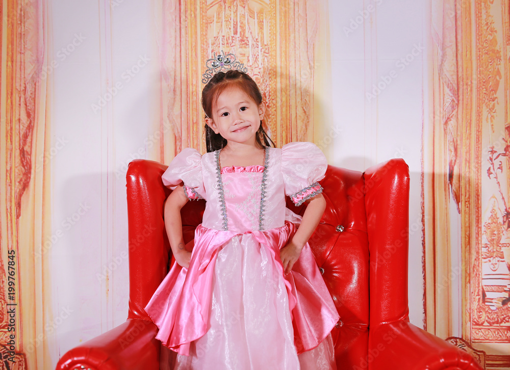 Little asian girl dressed as a princess. Child in pink princess dress ...