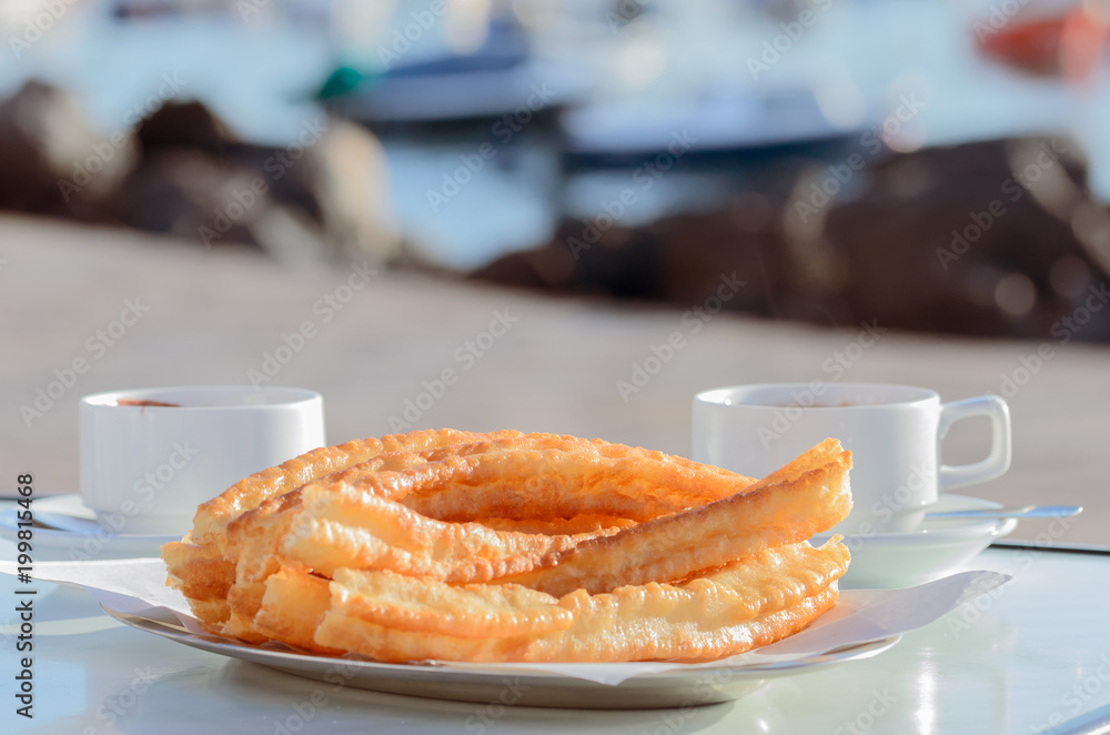 Typical Spanish snack churros are deep-fried pastries and served with ...