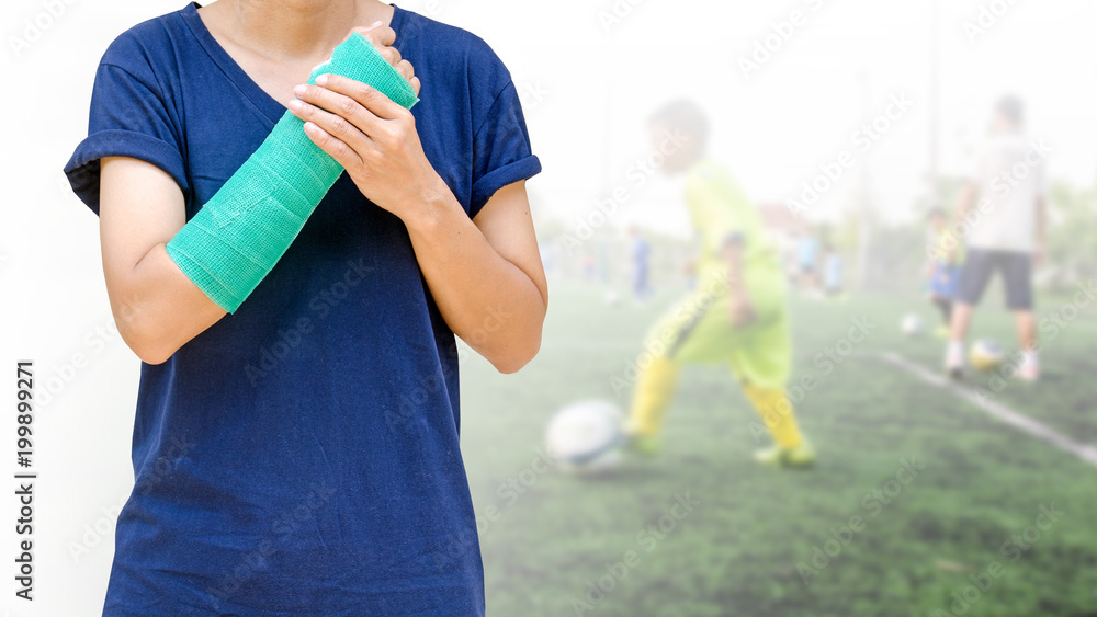 Injured sport player with wrist support or arm cast on hand and arm ...