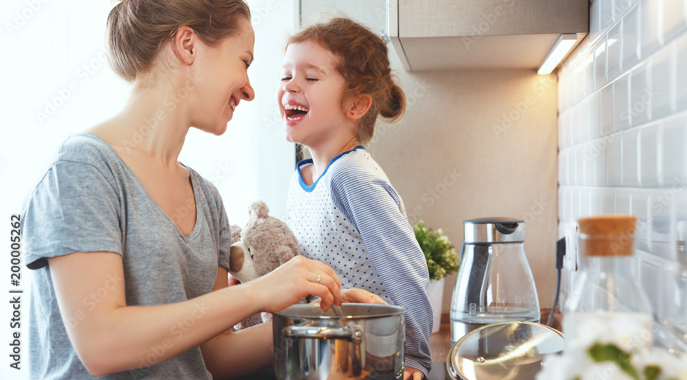 preparation of family breakfast. mother and child daughter cook ...