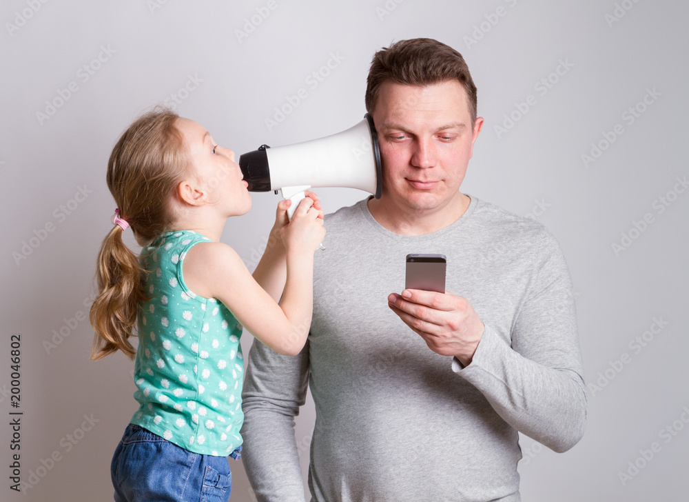 Father using smartphone ignoring his daughter Stock Photo | Adobe Stock