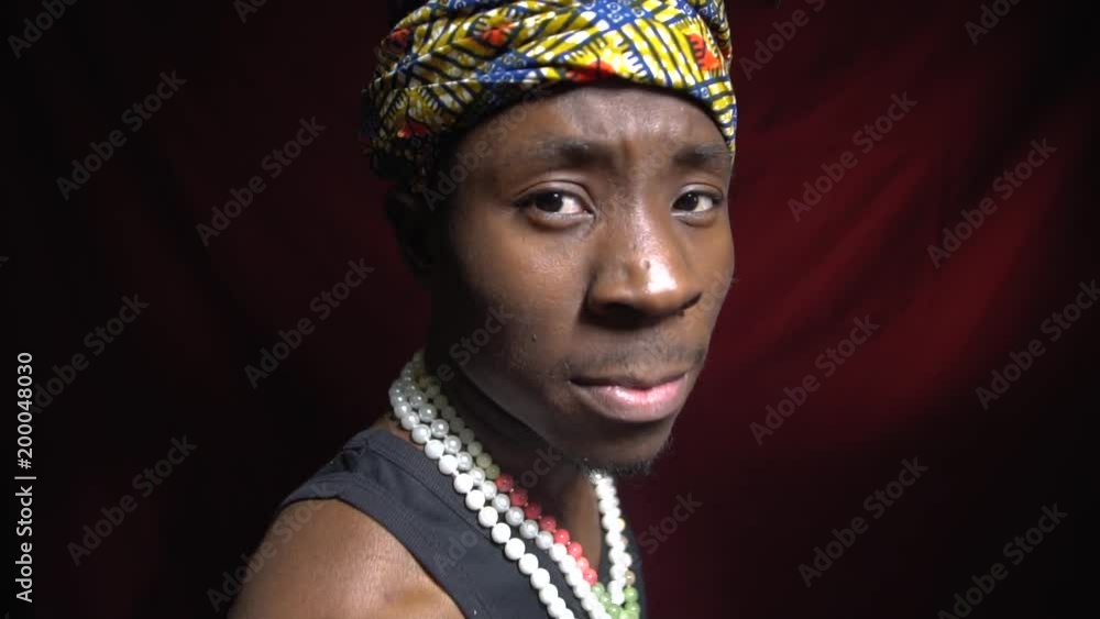 Black male from Angola in traditional headdress with beads around his ...