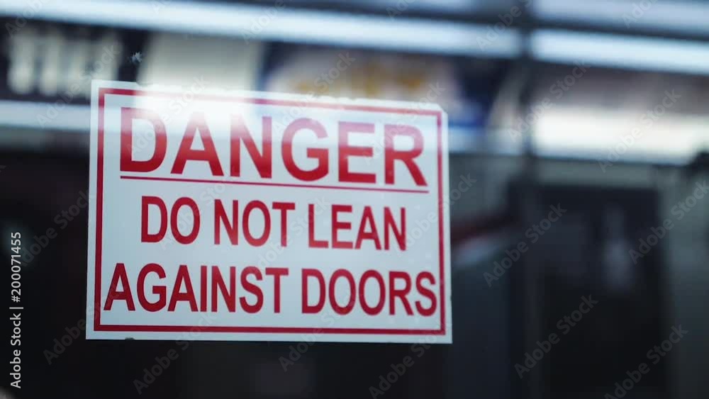 Warning sign saying Do Not Lean Against Doors on moving subway Stock ...