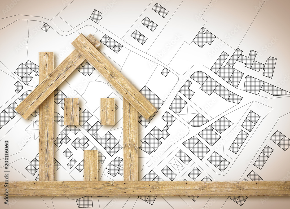 Conceptual wooden house over an imaginary cadastral map of territory ...