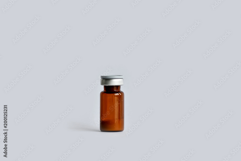 A vial (ampoule, container) with a drug (medicine powder) on a white ...