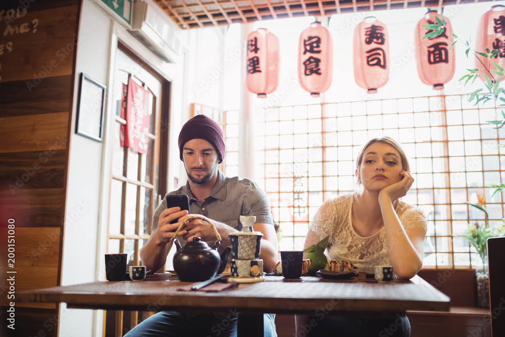 Man ignoring woman while using mobile phone Stock Photo | Adobe Stock