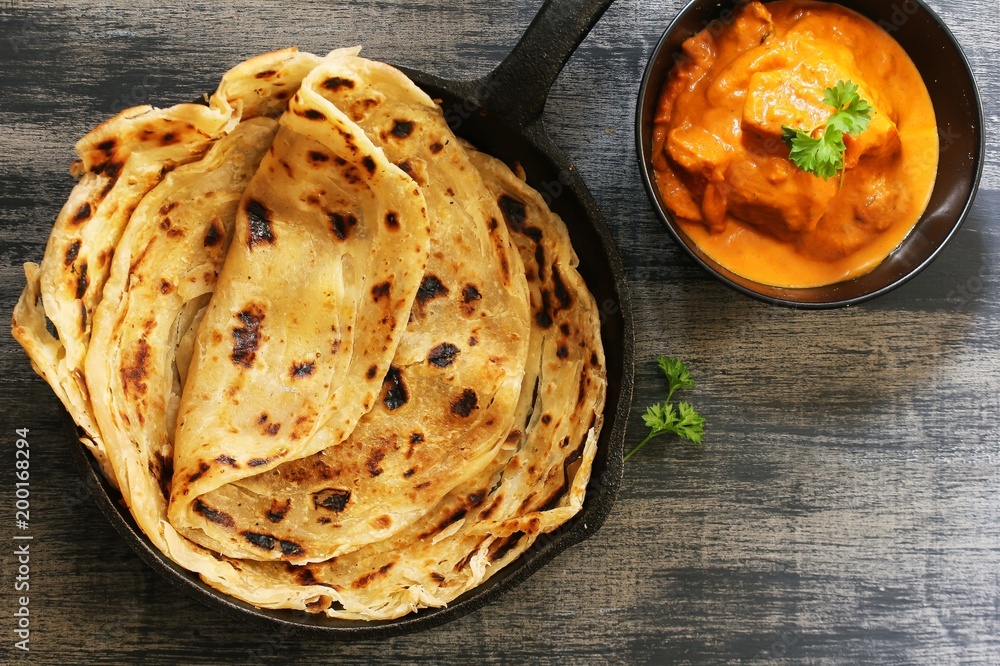 Homemade Kerala wheat paratha or layered parotta served with Paneer ...