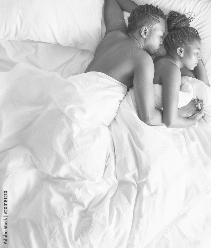 Black and white photo of African descent couple sleeping on the bed snuggling and hugging Stock ...