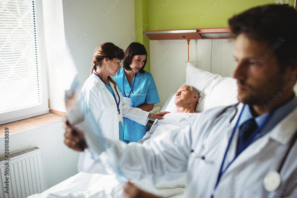 Female doctor consoling senior patient with nurse Stock Photo | Adobe Stock