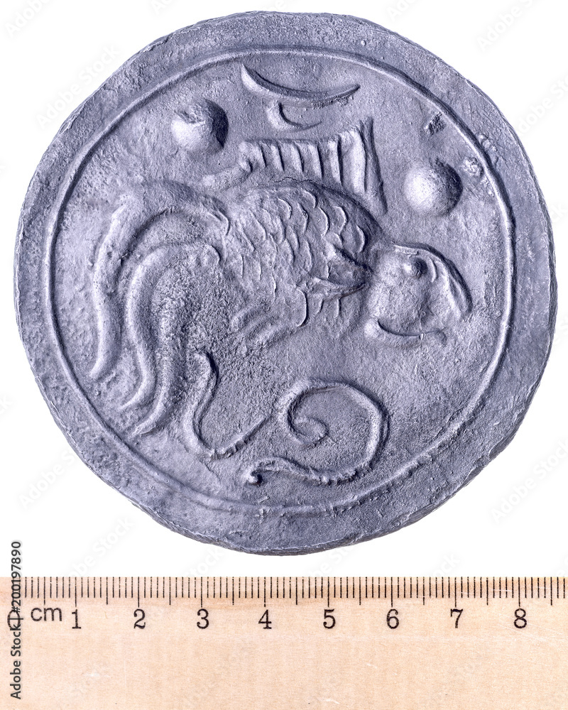 Ancient tin-zinc coin of Funan with a picture of a goldfish and a snake ...