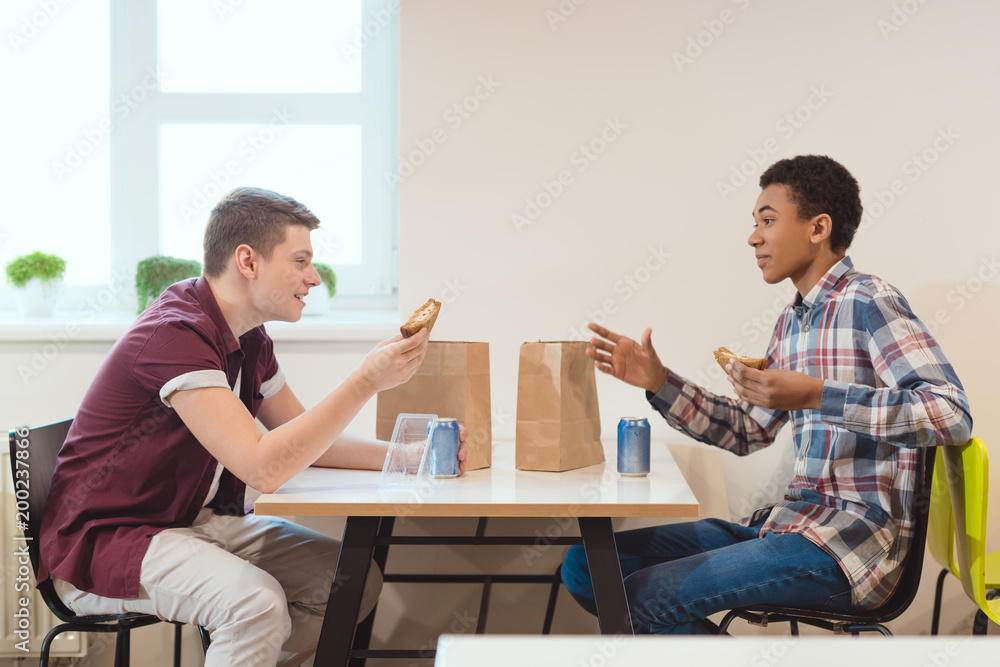 teenage schoolboys talking at school cafeteria during lunch Stock Photo ...