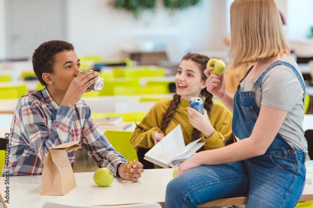 high school students taking lunch together at school cafeteria Stock ...