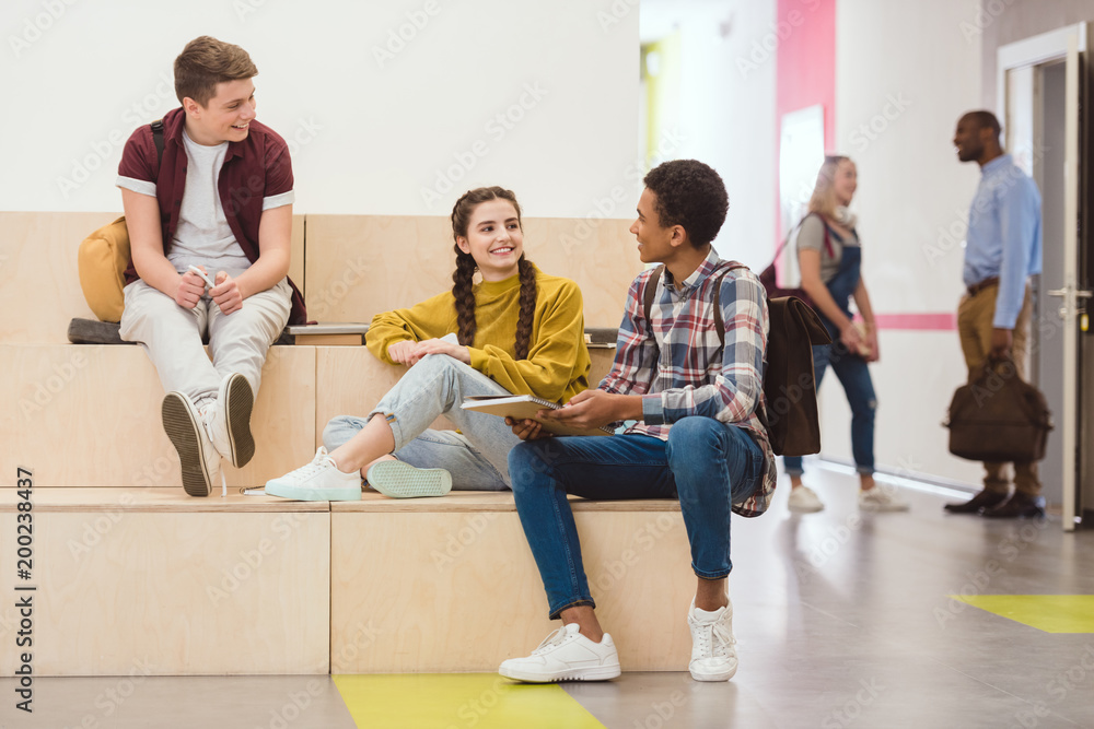 high school students sitting in lounge zone at school corridor Stock ...