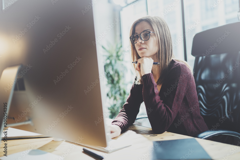 Attractive young businesswoman using desktop computer at modern working ...