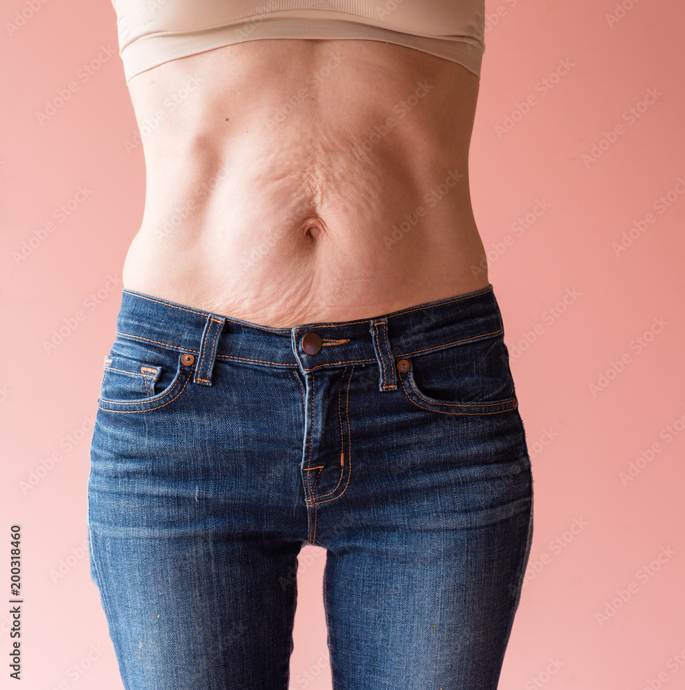 Midsection view of middle aged woman's bare natural looking stomach ...