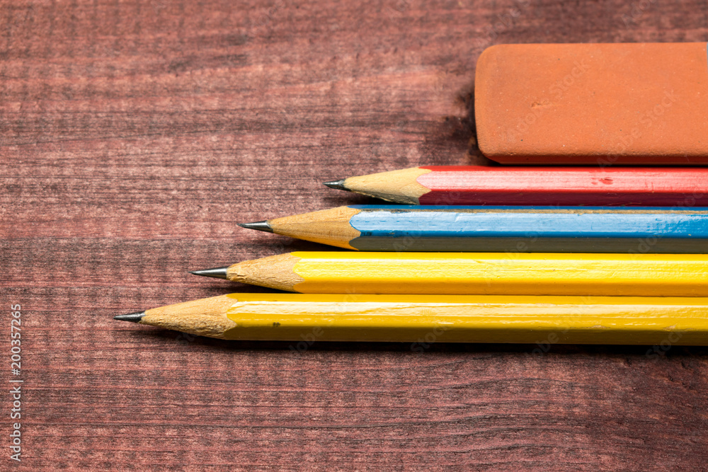Bright colorful pencils next to a blank sheet of paper. School supplies ...