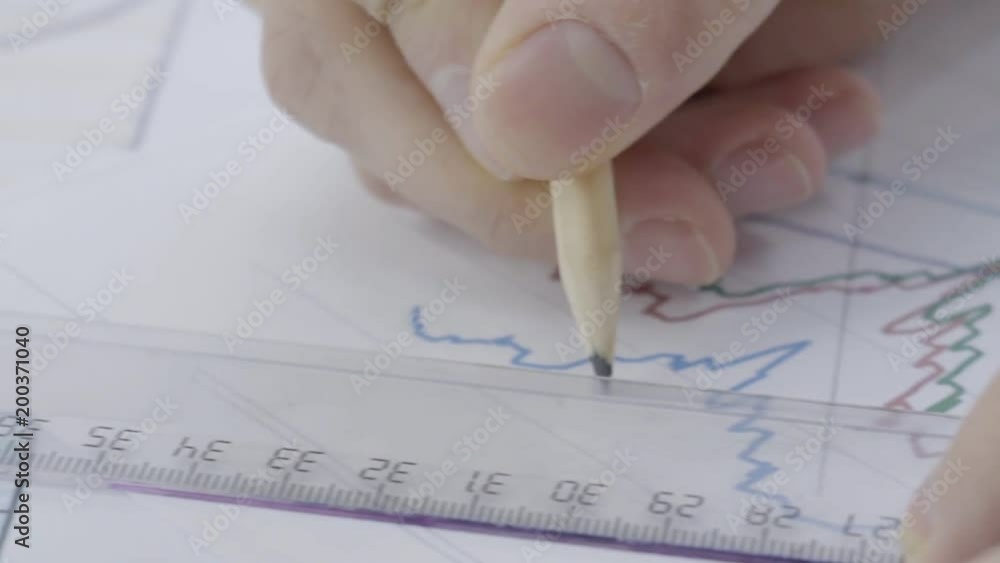 Close-up of fingers draw a line on a ruler on a color chart. Male hand ...