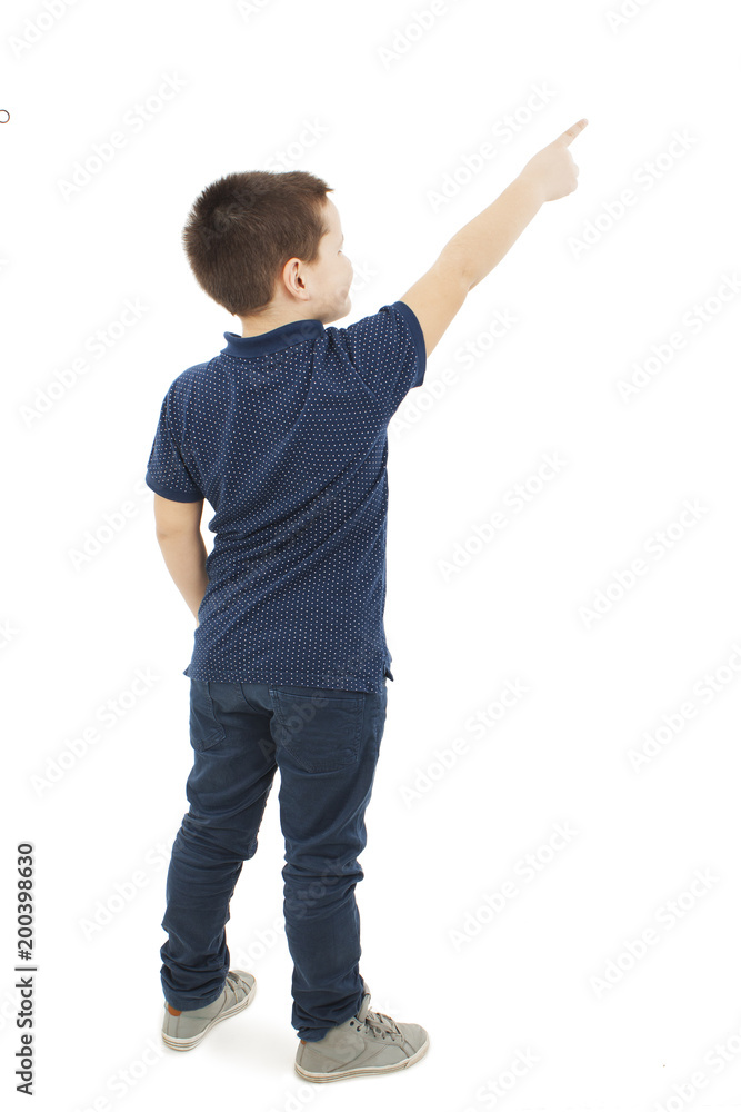 Back view of little boy points at wall. Rear view. Isolated on white ...