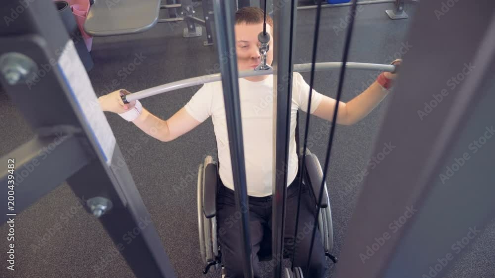 Strength of weak hands muscles by disabled man in a wheelchair. Stock ...