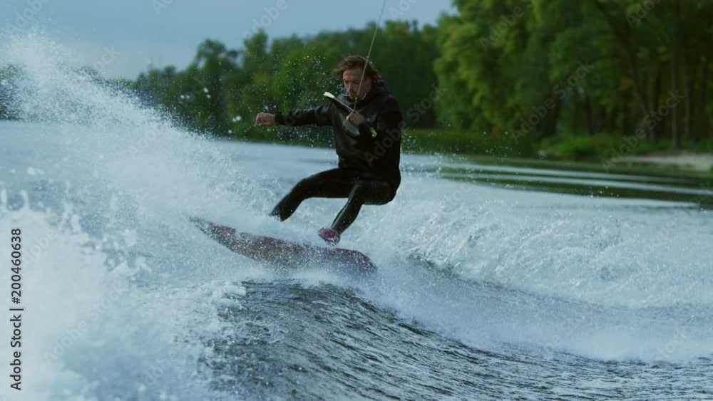Man riding wakeboard boat on river. Water rider enjoy waves. Extreme ...