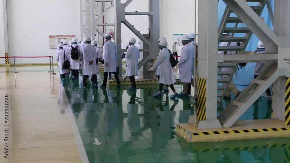 Shanghai, China-4March'18 excursion to factory, people in White robes ...