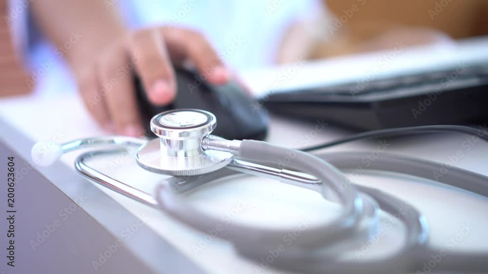 Medicine doctor's working using mouse on laptop computer with ...