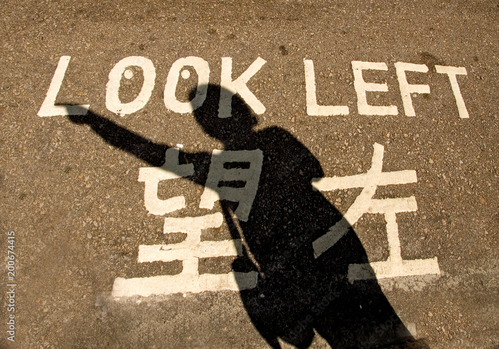 Shadow pointing left at crosswalk warning people to “Look Left” for ...