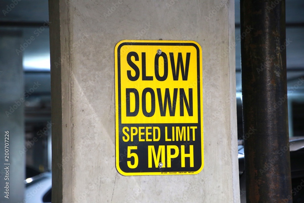 Yellow and Black Slow Down Speed Limit 5 Mph Sign in a Parking Garage ...