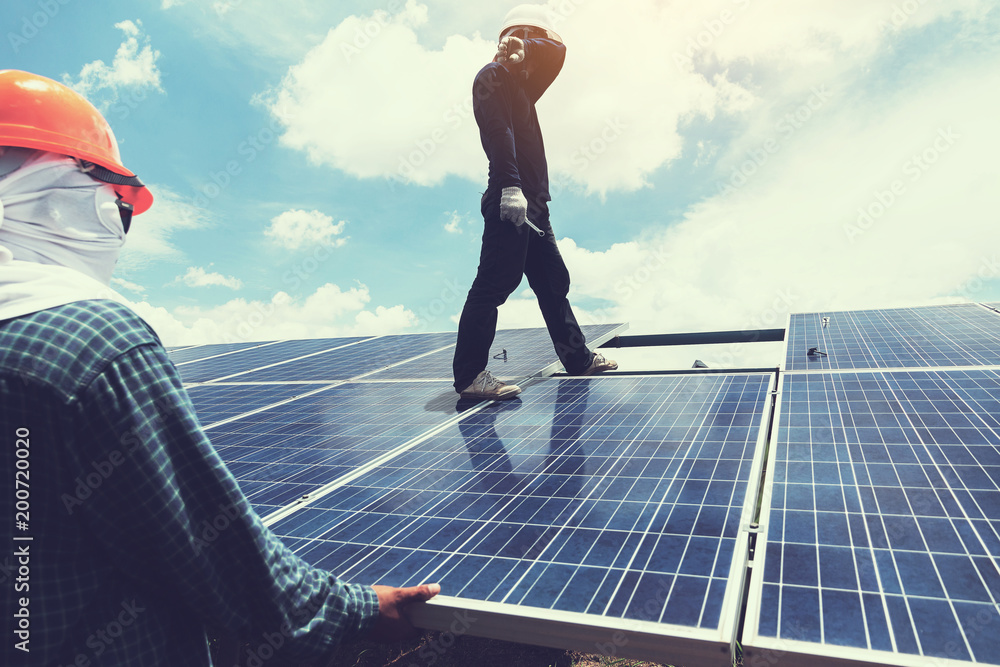 engineer team working on replacement solar panel in solar power plant ...